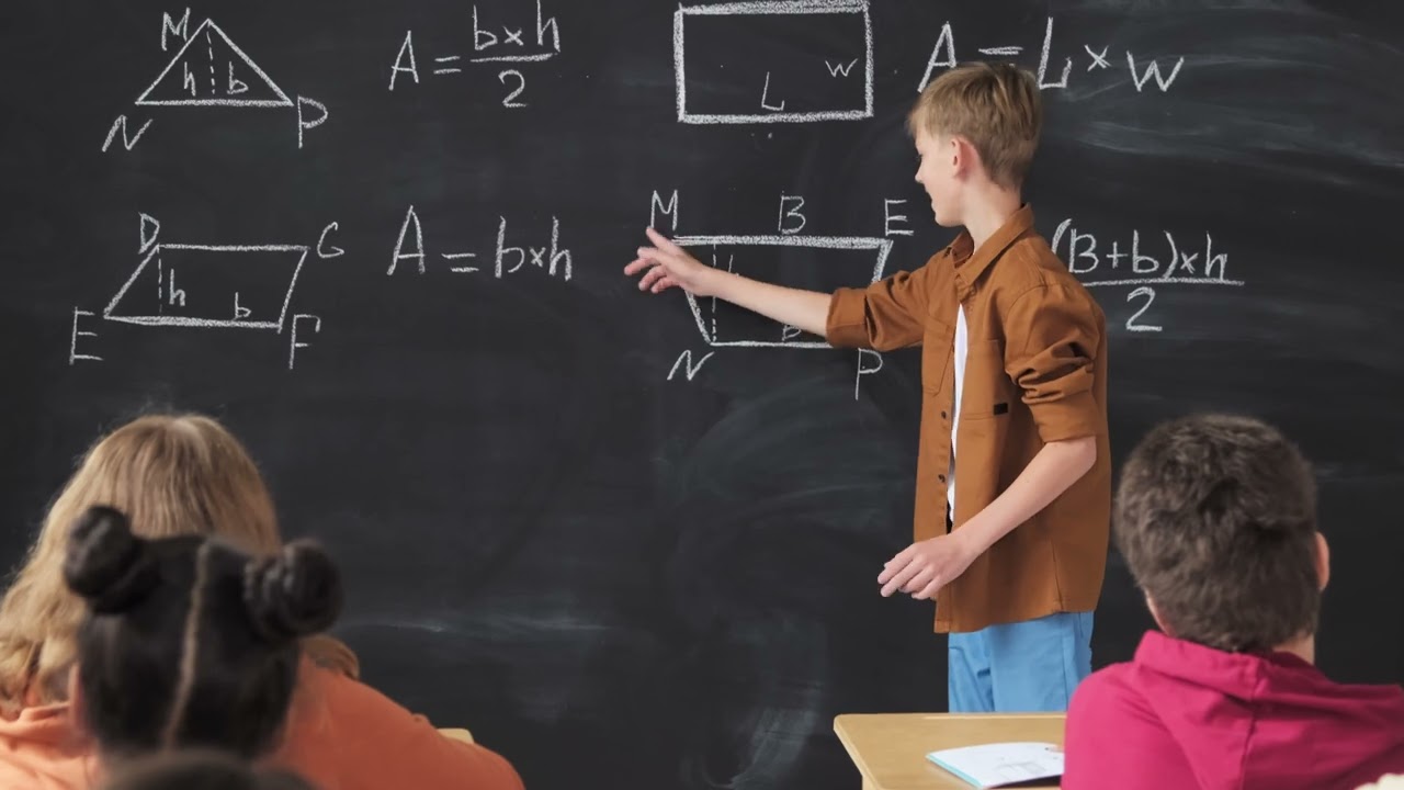 A Student Solving A Math Equation On The Blackboard
