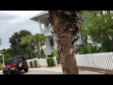 Driving golf cart through carillon beach resort community Panama City beach Florida
