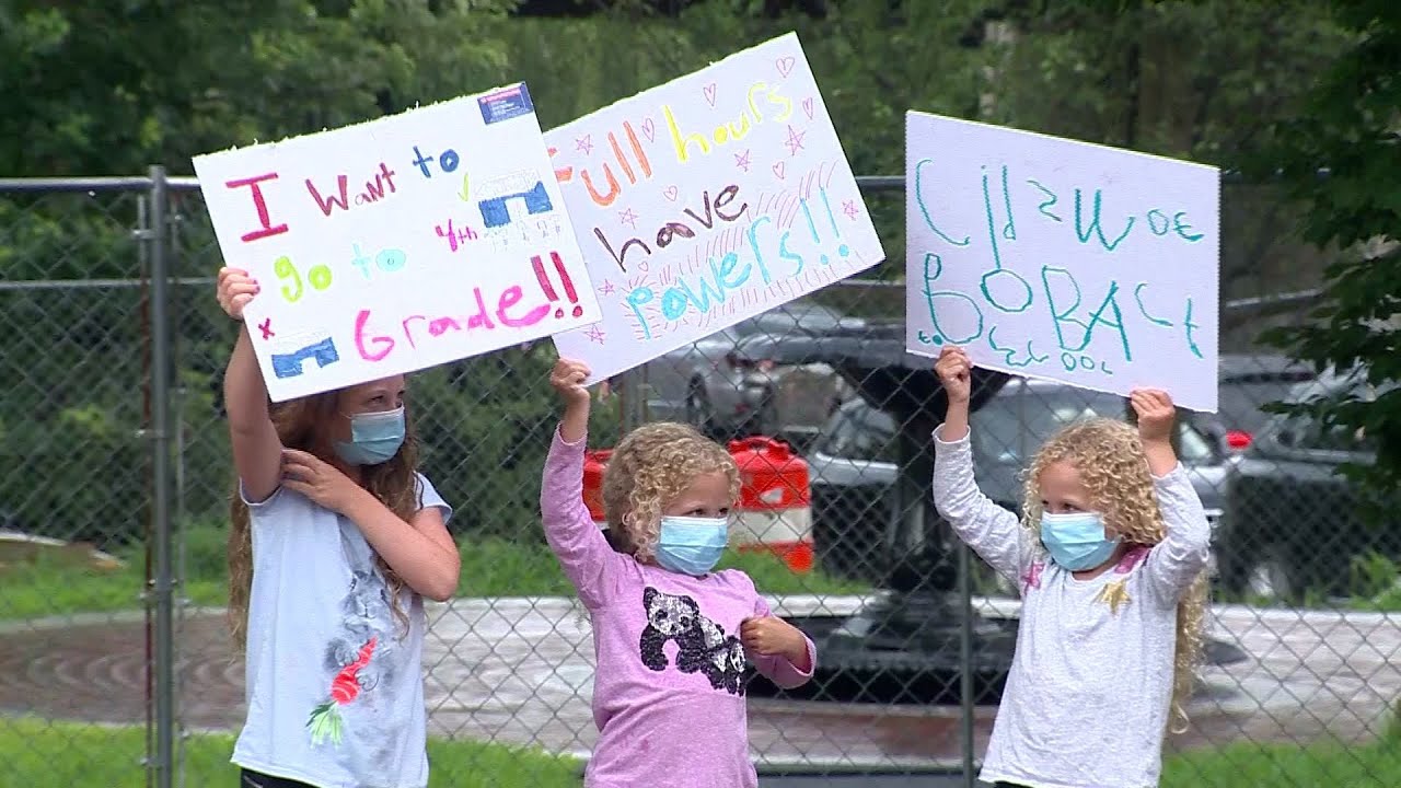 Parents protest with kids, calling for full return of in person elementary school