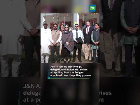 A delegation of diplomats arrives at a polling booth in Budgam to witness the polling