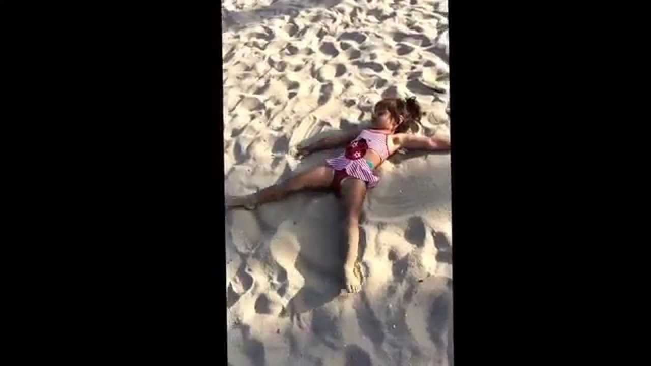 Gigi making sand angels