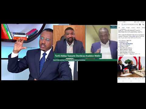 Dr. Lammaan harka walakkaa baaseera jadhe obbo Taayyee Danda'aa. Dr. Lammaan immoo ani hin hirmanne