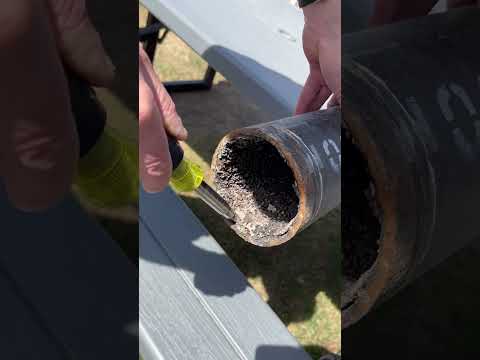 Chemical deposits from the mop sink caused back flow.