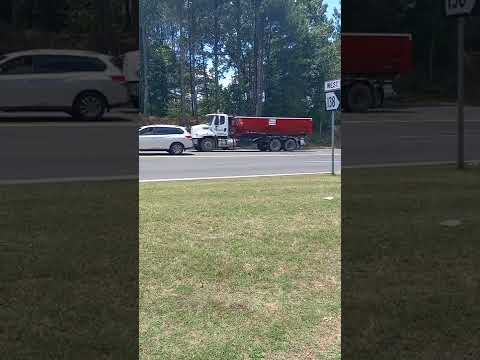Beautiful Freightliner dump truck with new looking less vertical red container can drop off pick up
