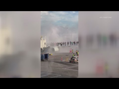 American Airlines plane catches fire at Denver airport.