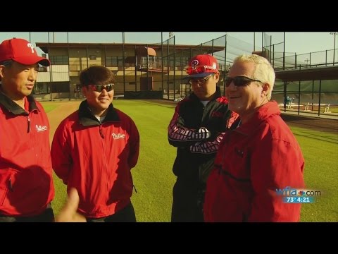 Baseball field grounds keeper teaches foreign colleagues