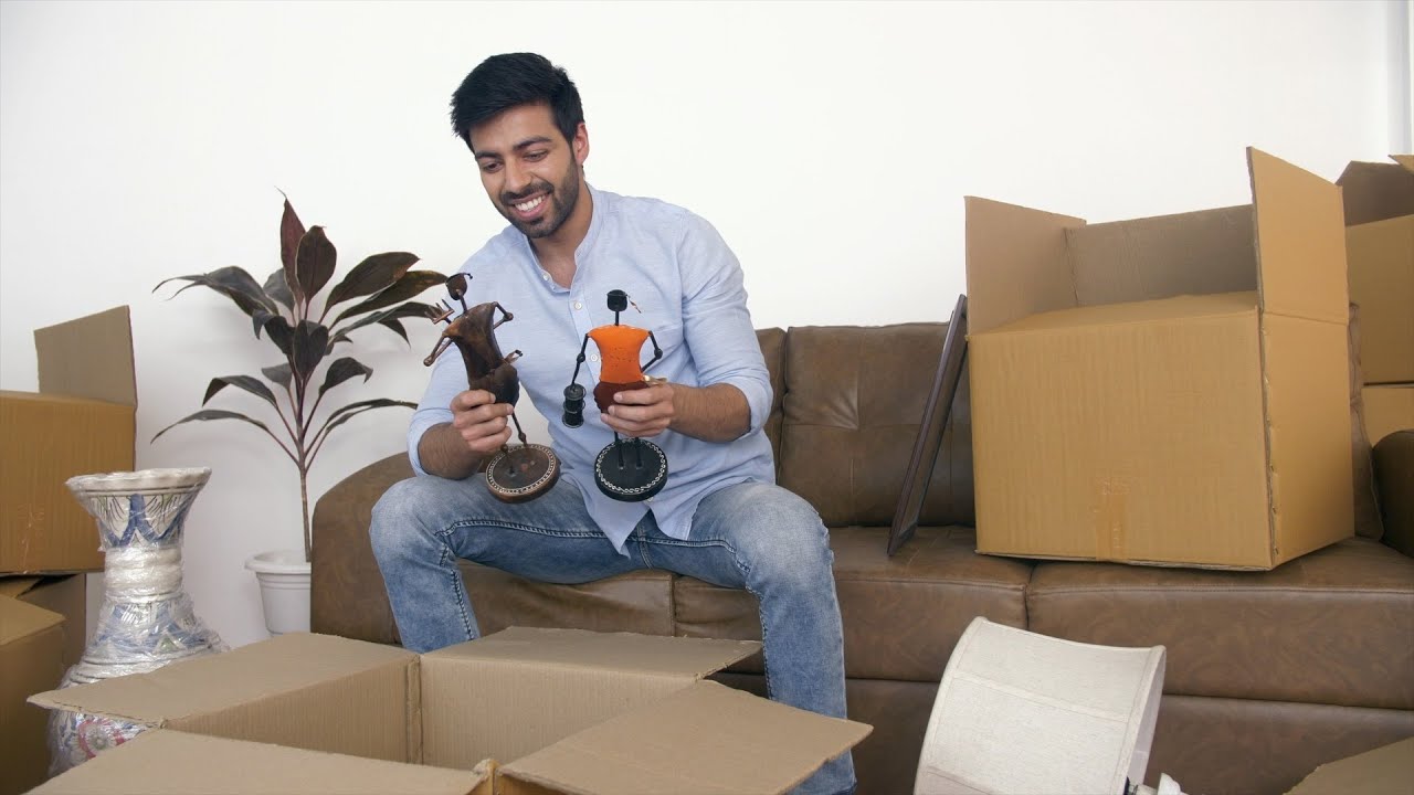 Young Indian man unpacking cartons - moving boxes | Indian Stock Footage | Knot9
