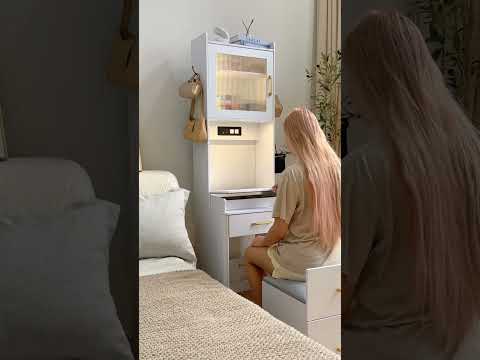 (419) ▶️ This makeup vanity table has a sleek mirror surrounded by bright lights.