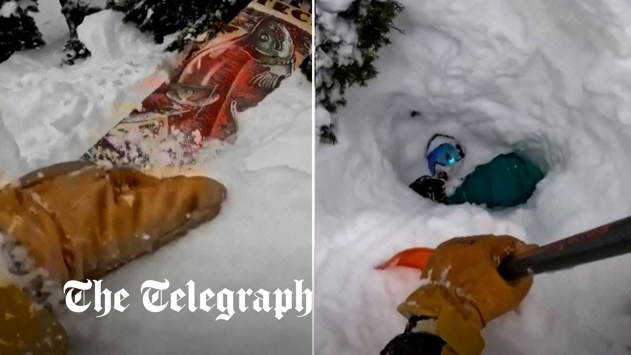 Skier uses hands to dig for snowboarder buried deep in snow