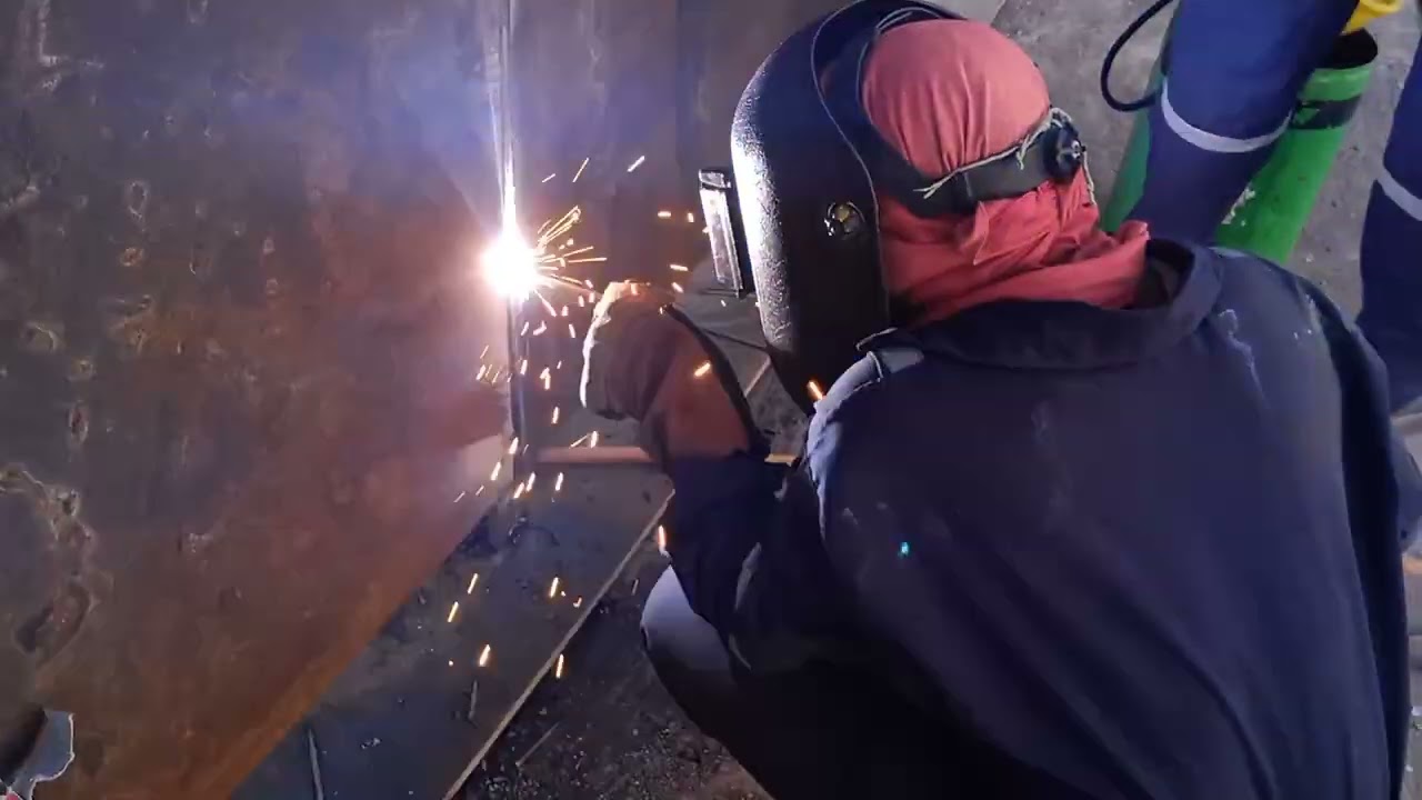 Shell plate vertical joint welding and grinding