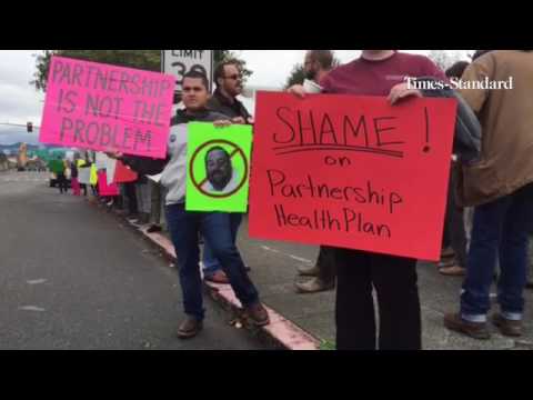 Protestors stood near Partnership HealthPlan of California offices calling for local nursing homes t