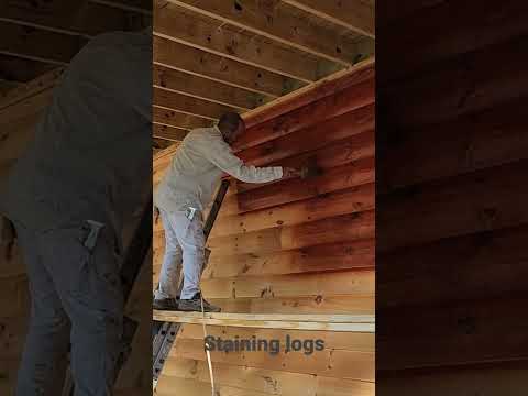 Staining logs with Sikkens. The color is Mahagony.