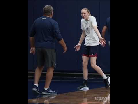 Paige Bueckers playfully arguing with Geno Auriemma