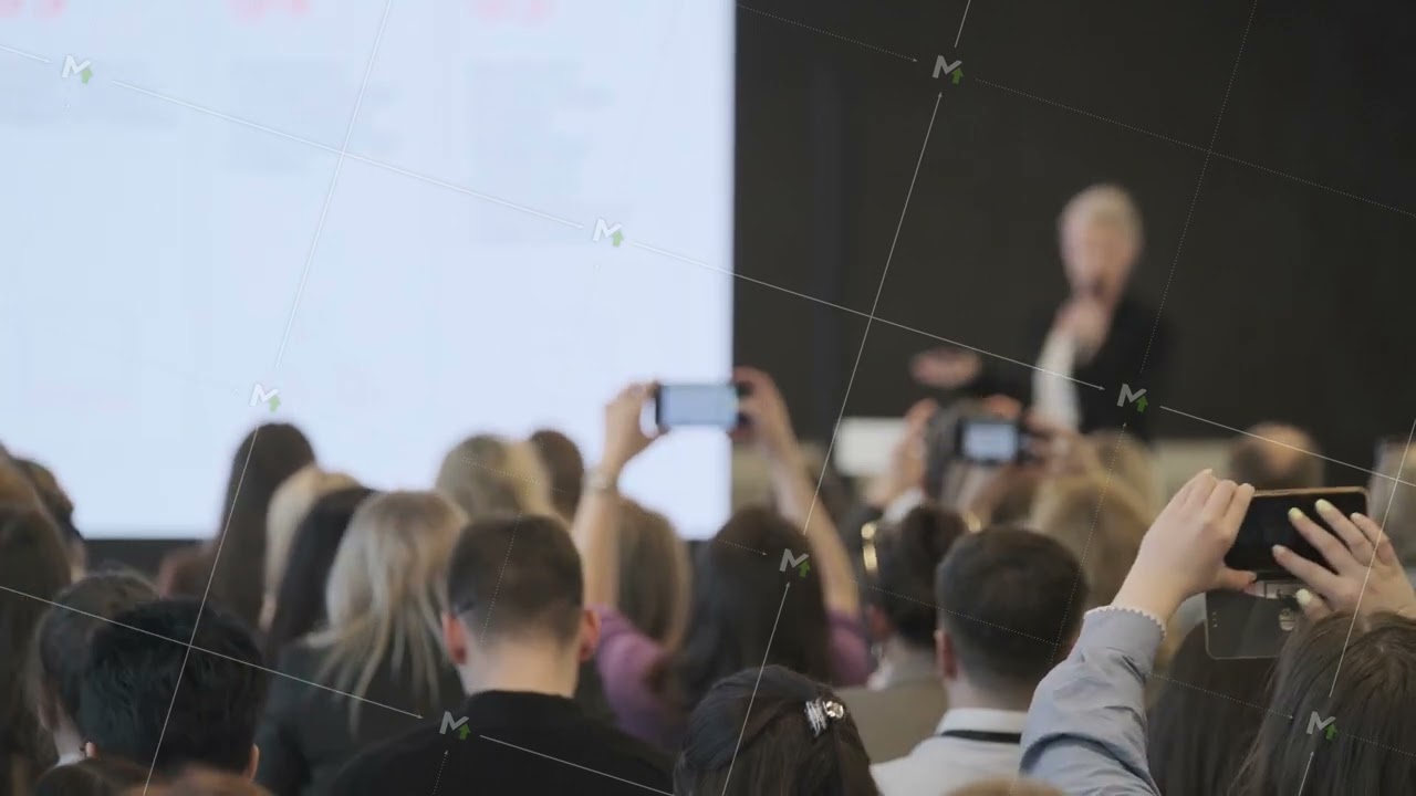 Audience listening to speaker at business technology conference presentation during TechWeek event