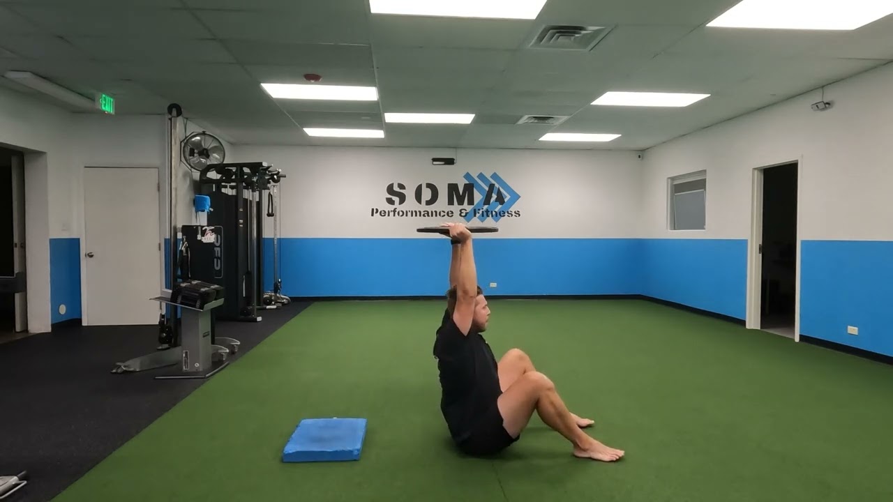Weight Plate Press Sit Up