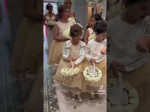 Flower girl and brides maid walking down the Aisle bride