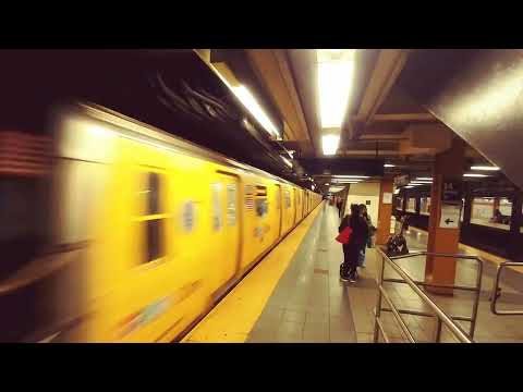 IND 8th Avenue Line: Half-Wrapped E train leaving 14th Street