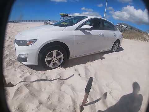 man gets rental car stuck on Panama City Beach fl. lifeguards come to help