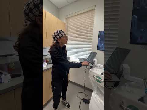 "Robotic Assistance: Dr. Schaumberg Preparing to Place Three Implants"