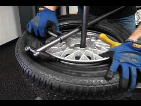 Change a car tire on a No-Mar scratch proof tire changer