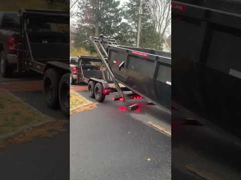 Maxx D roll off trailer pulling 14 yard dumpster