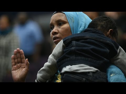 New citizens read Naturalization Oath of Allegiance to the United States