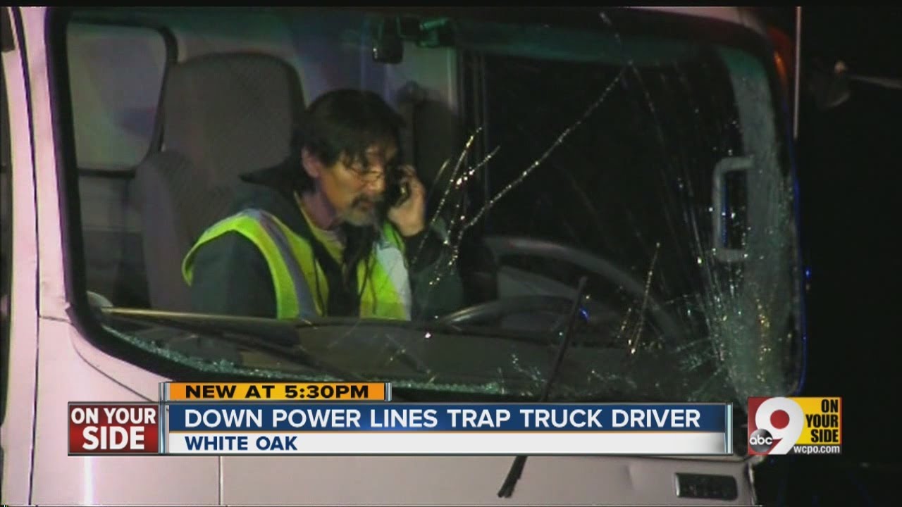 Down power lines trap truck driver