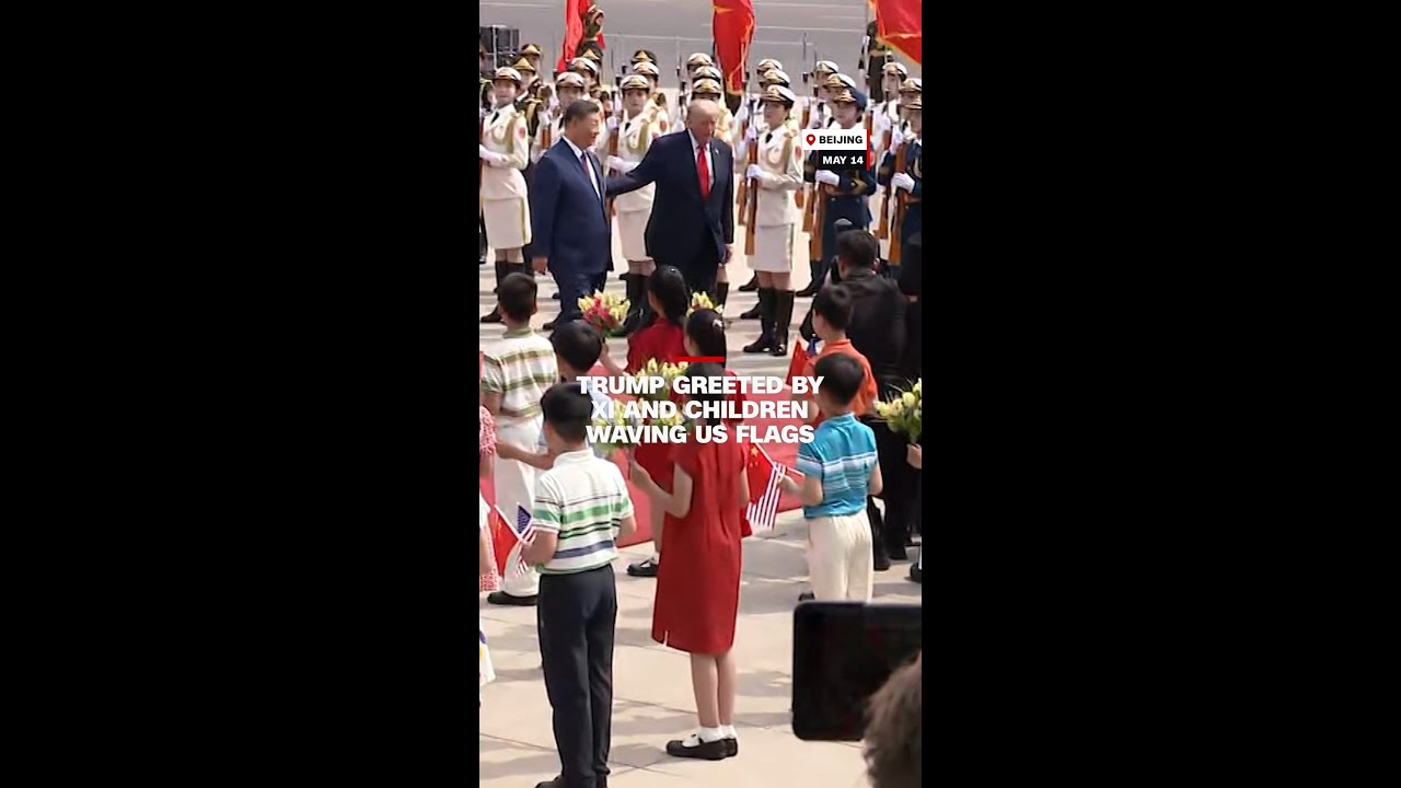 Trump greeted by Xi and children waving US flags