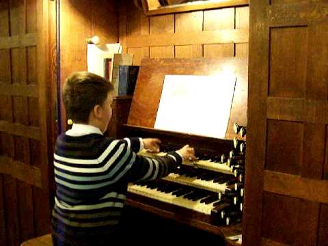 Boy (9) plays on tracker action organ