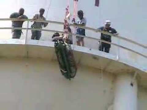 Workers rescue a man off a water tower