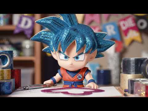 Goku Glitter stands in a craft room, fists clenched