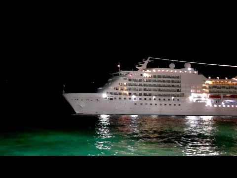 Cruise ship night time SEVEN SEAS NAVIGATOR leaving Oranjestad port in Aruba