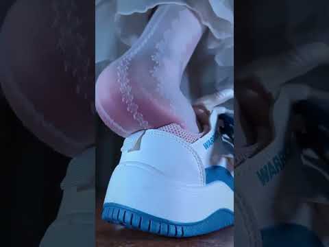 A woman measures white and blue sneakers