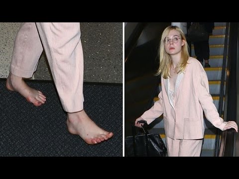 Elle Fanning Shows Off Her Funky Feet While Barefoot At LAX
