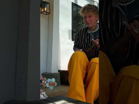 Machine Gun Kelly plays ukulele to baby daughter