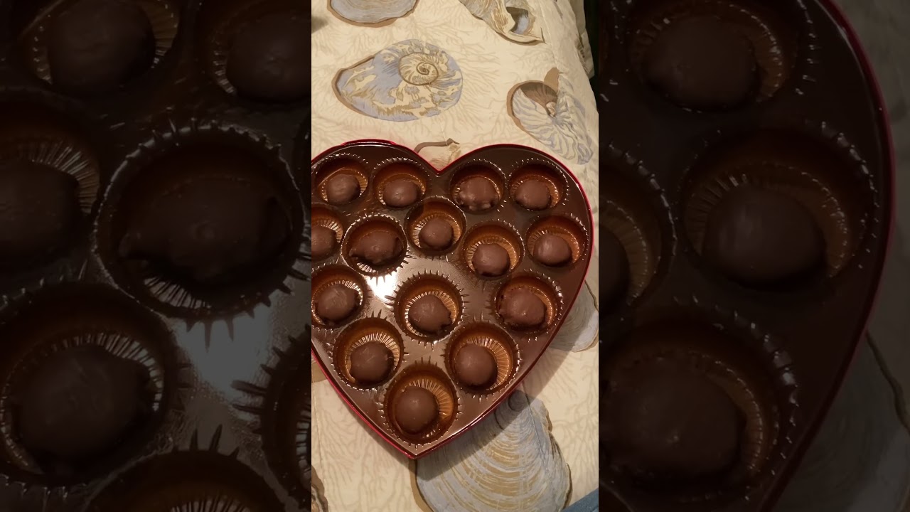 Unboxing a heart shape box of chocolates.