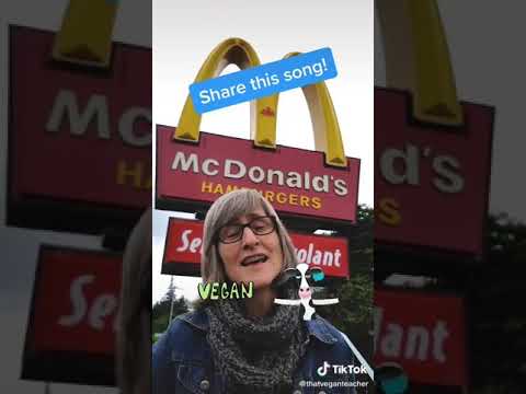 Miss Karen sings a vegan song in front of McDonaldโs