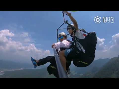 Have a duo paragliding at Longli Grassland in Guizhou