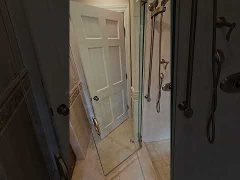 Restoring a natural stone shower with glass walls.