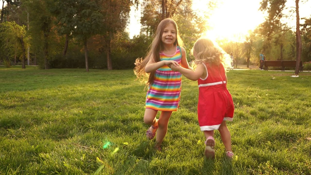 Two sisters holding hands circling