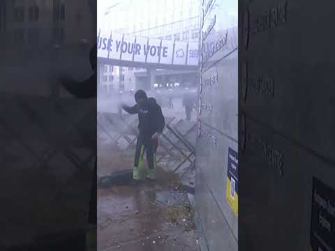 Police hose European farmers protesting in front of EU parliament