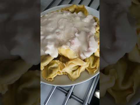 spinach ricotta ravioli with a white chicken sauce