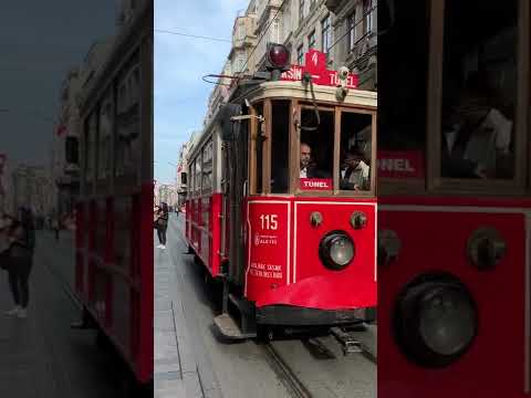 Tram running on road.