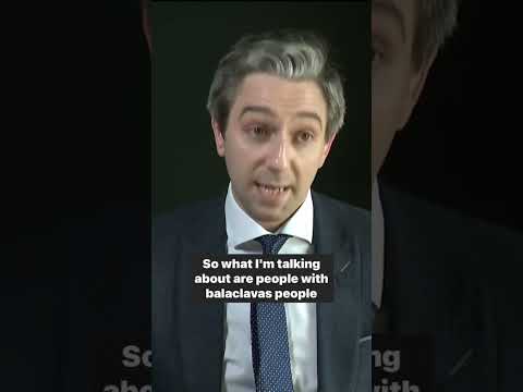 Simon Harris reacts to migrant protesters wearing "balaclavas" & "brandishing" the Irish tricolour