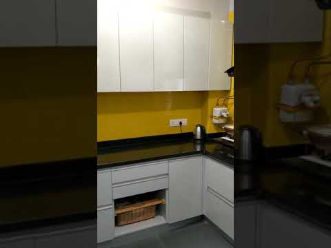 Modular Kitchen in Light Grey with Yellow tiles contrast..