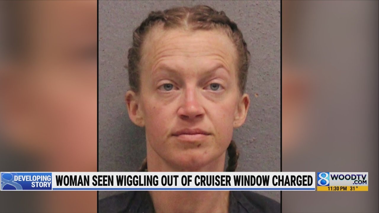 Woman seen wiggling out of cruiser window charged