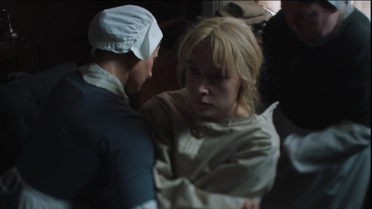Blonde girl in straitjacket