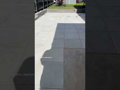 600 x 600mm concrete pavers with a stunning charcoal Sydney stone wall