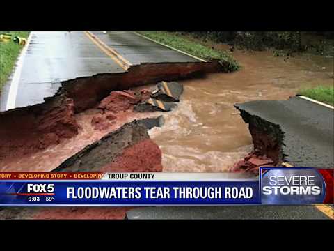 Troup County floodwater tear through road