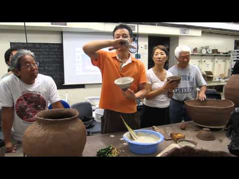 Lee Kang Hyo applying slip on tea bowls